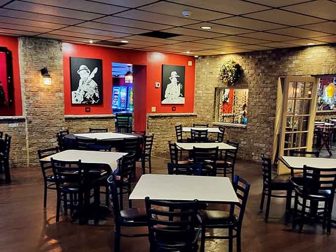 Warm brick walls and bold red paint set the mood before a single bite arrives.