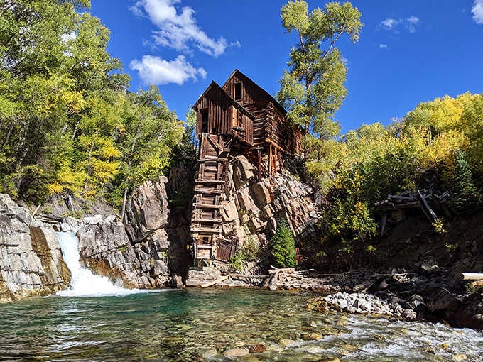 The Crystal Mill's plunge pool gleams impossibly turquoise, making you wonder if nature hired a color consultant for this project.