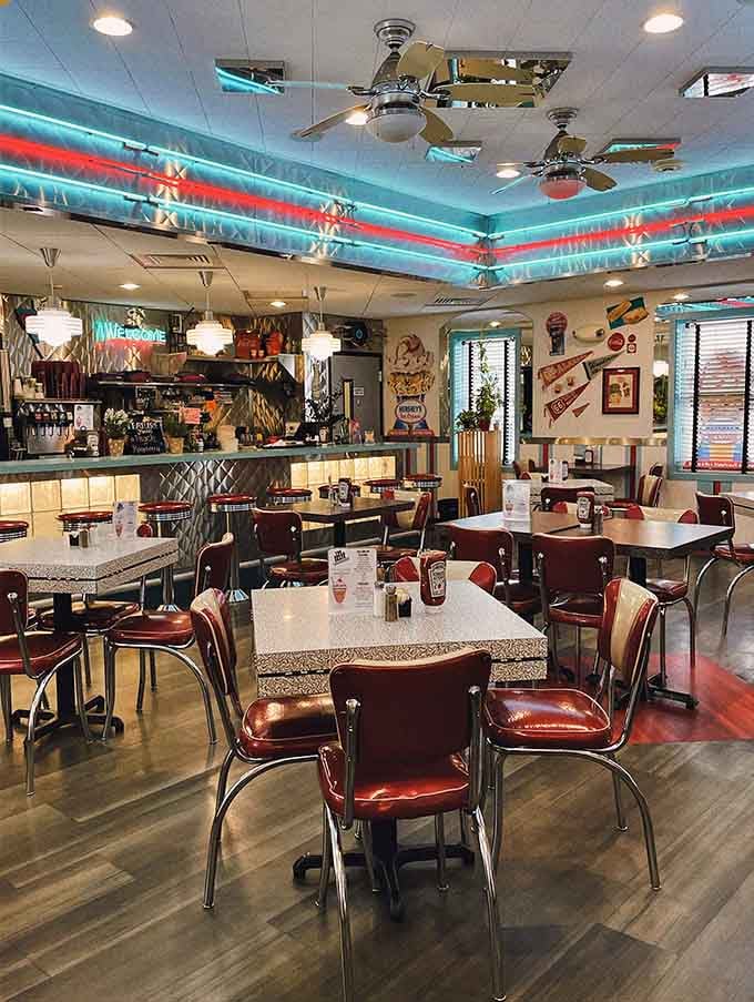 Red vinyl chairs, chrome accents, and neon glow overhead, this is what happiness looks like from the inside.
