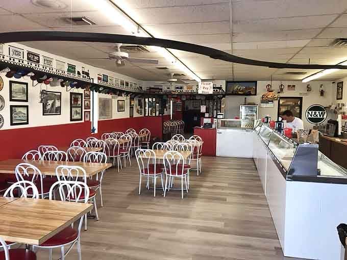 White bistro chairs, bold red walls, and a model train track overhead &mdash; this parlor means serious, delicious business.