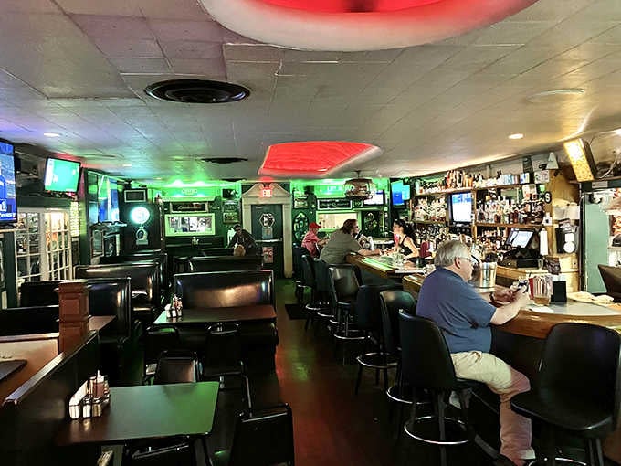 Dark wood, green walls, bar stools lined up just right. This room has been making people feel at home for a very long time.