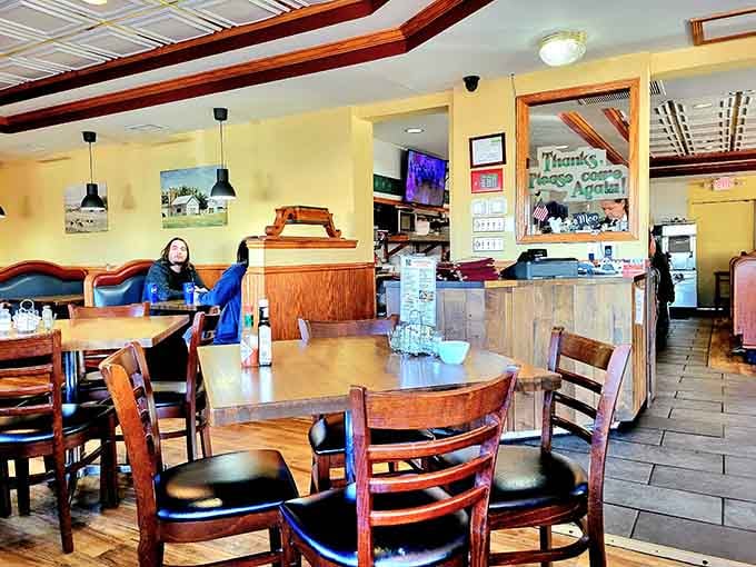 Warm yellow walls, wooden tables, and a "Thanks, Please Come Again" sign that actually means every word.