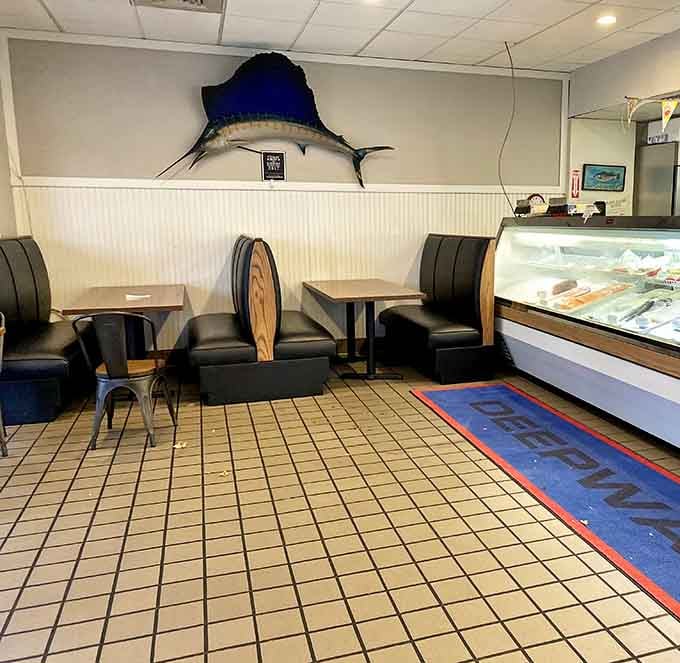 A majestic marlin watches over diners while the seafood case beckons with ocean treasures just steps away.