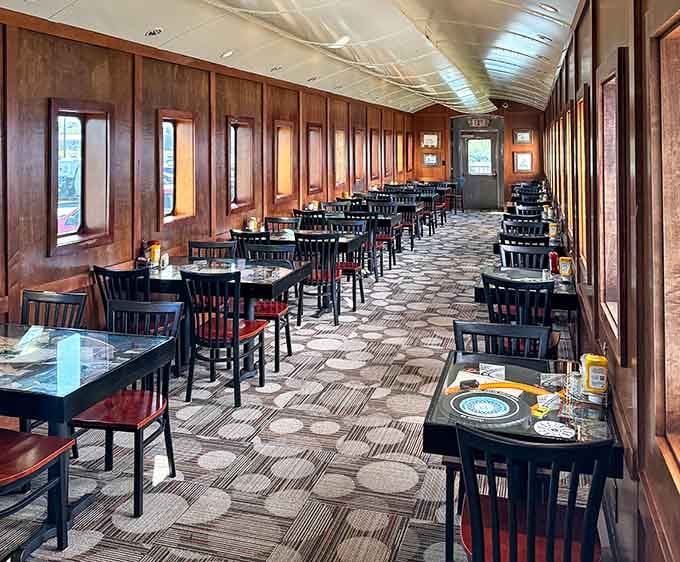 Warm wood paneling, curved ceilings, and oval windows. Dining here feels like riding first class on a train that never left.
