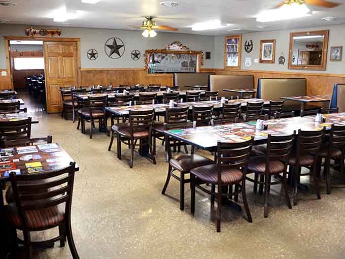 Warm wood tones, rustic star d&eacute;cor, and ceiling fans spinning overhead, this dining room means serious business.