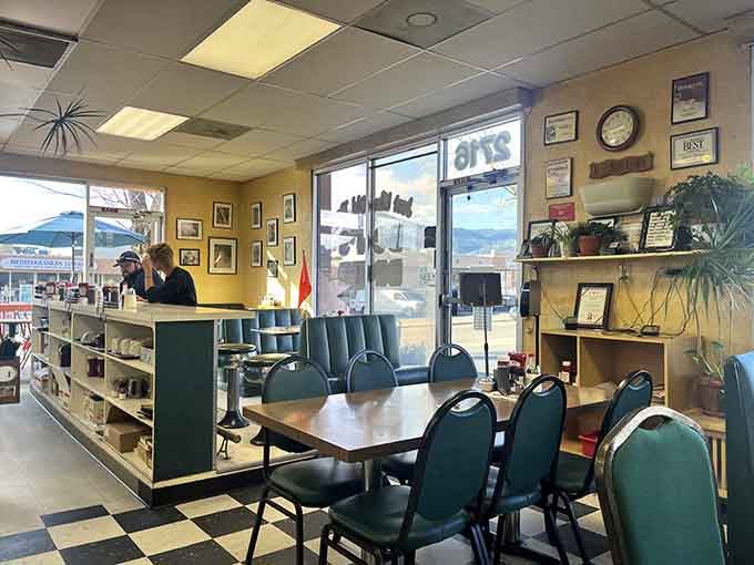 Black and white checkered floors, warm yellow walls, and green booths. Norman Rockwell would feel right at home.