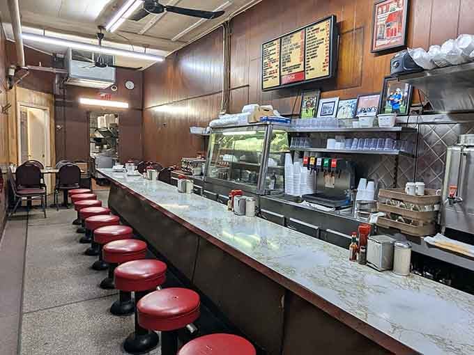 Red stools, wood-paneled walls, and a marble counter that's heard more good conversations than any therapist's couch.
