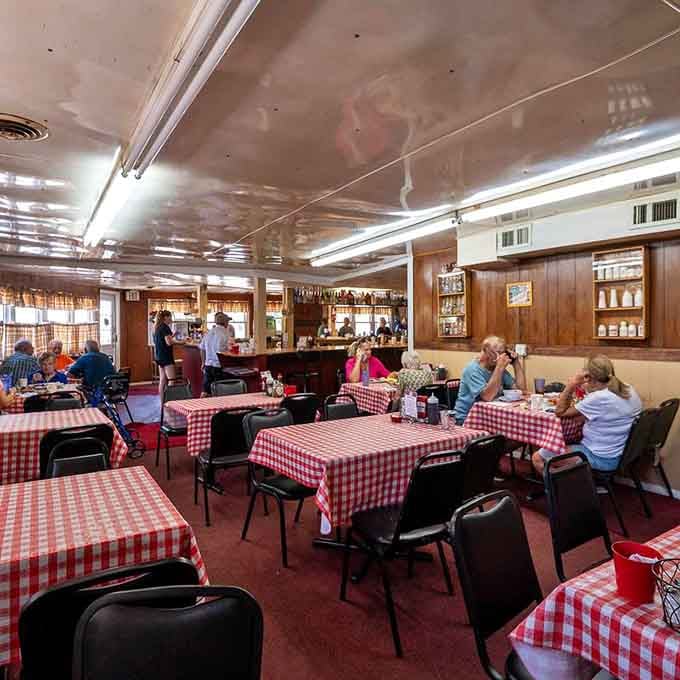Red-and-white checkered tablecloths and wood paneling create the kind of atmosphere Norman Rockwell would've painted between meals.
