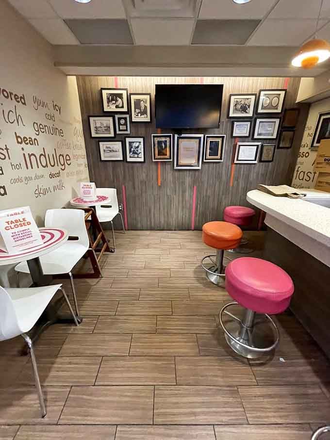 Those vintage photos and colorful stools create a museum vibe, except this one serves fresh glazed donuts with your history lesson.