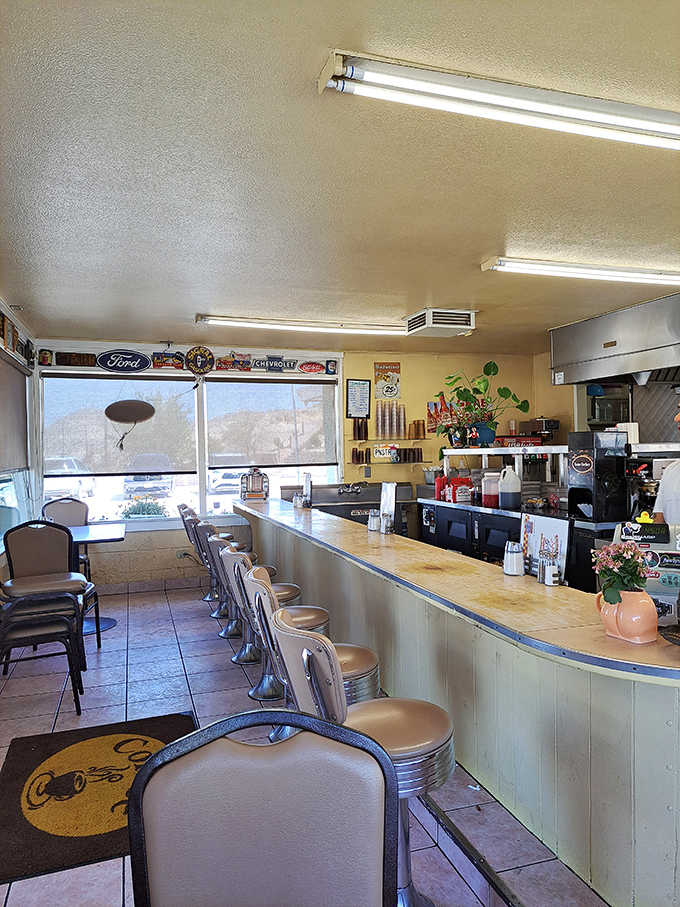Chrome stools, Ford and Chevrolet signs, warm lighting. This counter has heard a thousand good stories.