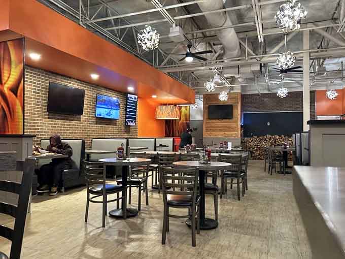 Bold orange walls, exposed brick, and chandelier lighting prove that great burgers deserve a seriously cool backdrop.