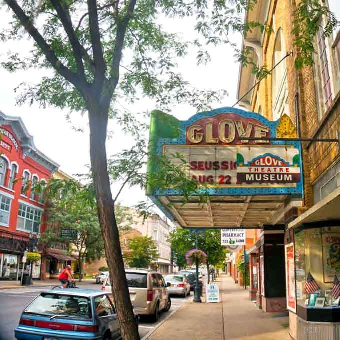 That vintage Glove Theatre marquee glows with the kind of charm Hollywood forgot how to make.