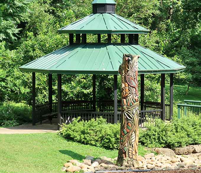 That carved wooden totem standing guard by the gazebo isn't just decoration, it's the park's way of saying hello.