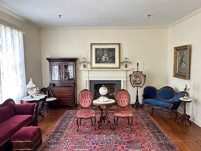 Victorian parlor perfection, complete with pink tufted chairs and a fireplace that once warmed the Keller family.