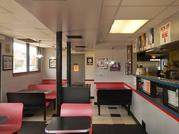 Red booths, Route 66 posters, and a "Pick Up Here" sign overhead, this dining room is a love letter to classic American simplicity.