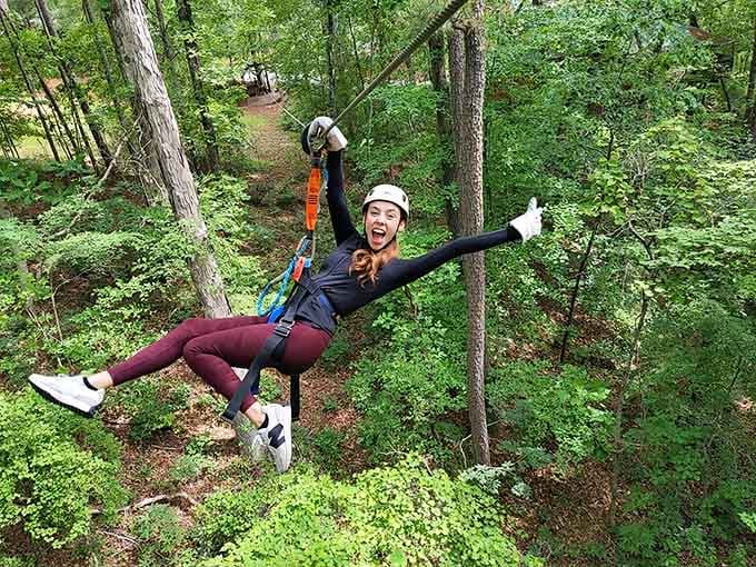 Pure joy, arms wide open, flying through the Georgia forest canopy like nobody's watching.