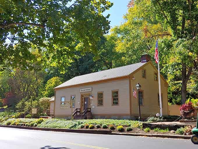 Tucked beneath a canopy of autumn trees, this schoolhouse stands like a postcard that never got mailed.