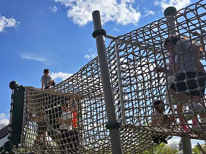 Kids navigate this net tunnel like tiny adventurers, proving that the journey matters more than the destination.