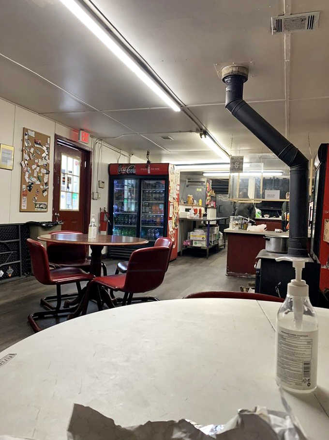Red chairs, round tables, and a smokestack through the ceiling. This room means business.