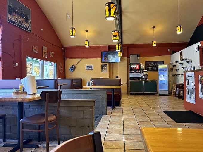 The red and yellow walls create the kind of welcoming vibe that makes strangers feel like regulars instantly.