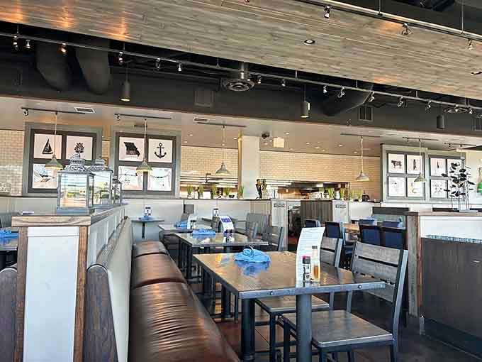 Leather booths, nautical artwork, and pendant lights create a dining room that feels like a warm coastal hug.