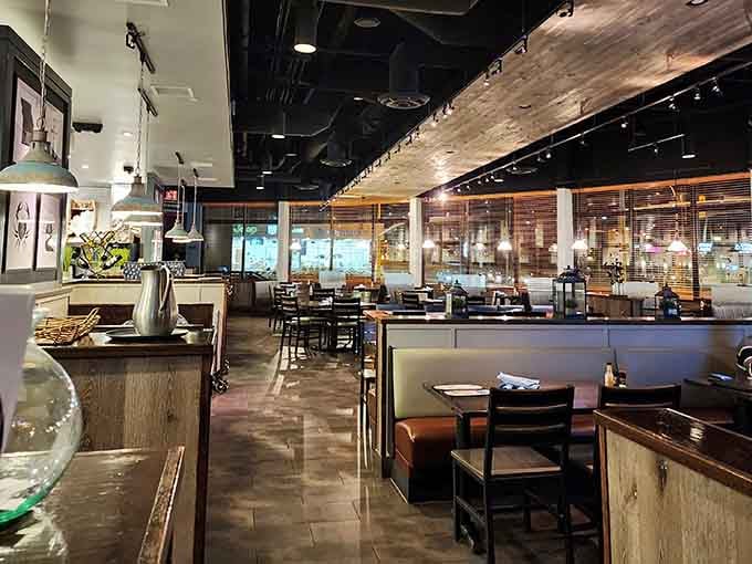 Warm booths, pendant lights, and wood details, this dining room says "stay a while" and means it.