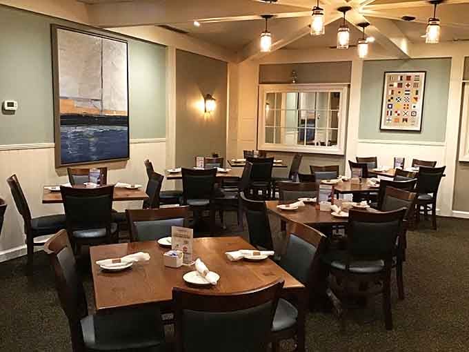 Warm lighting, coastal artwork, and neatly set tables, this dining room says "relax, you're exactly where you should be."