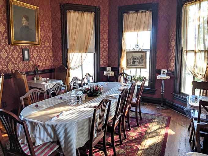 Red damask walls, white linens, and a portrait watching over dinner, grandmother's house never looked this good.