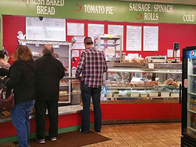 The bright red walls and packed counter at Napoli's say everything you need to know: serious food, zero pretension.