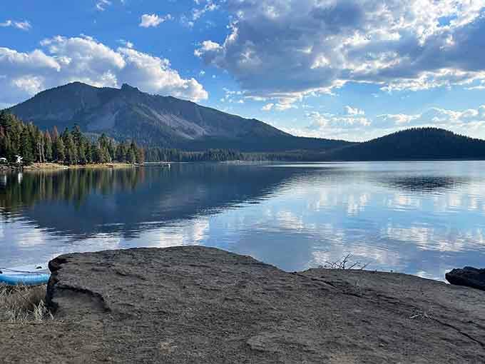 Paulina Lake on a cloudy day, so perfectly still it looks like the mountain is admiring its own reflection.