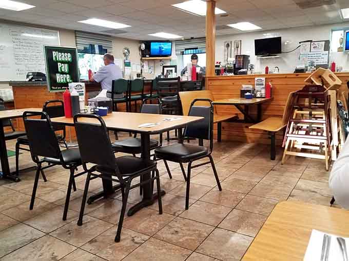 Tile floors, wooden paneling, and a "Please Pay Here" sign. Honest, unpretentious, and exactly where you want to be on a Saturday morning.