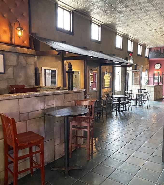 Stone walls, warm lighting, and a pressed tin ceiling that says, "Stay a while, you've earned it."
