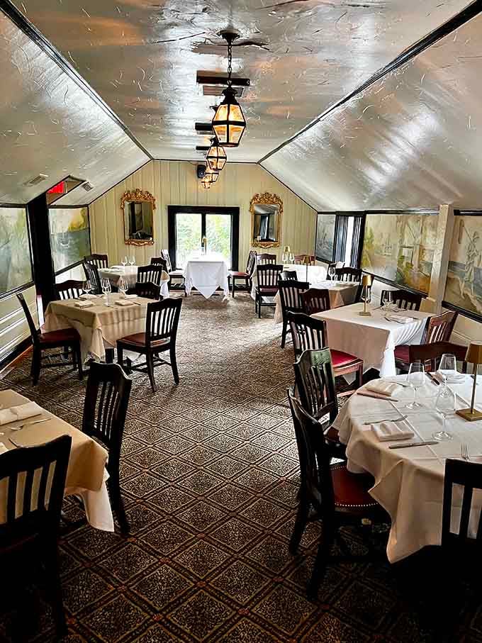 Golden lanterns, white tablecloths, and gilded mirrors make this dining room feel like a scene from Downton Abbey.
