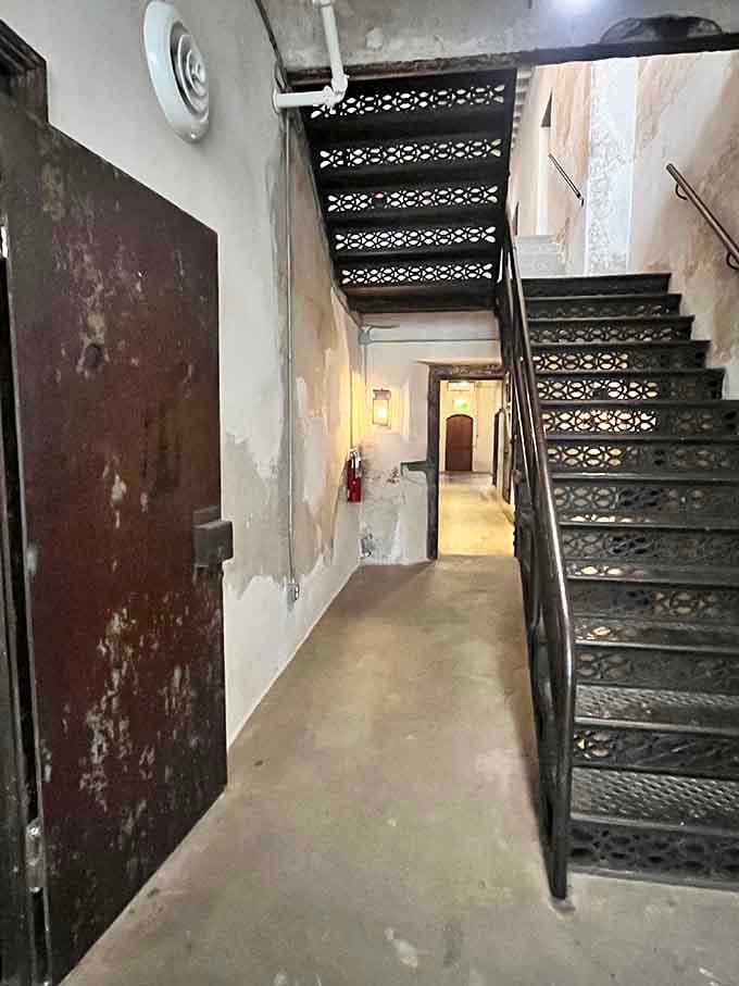 That ornate ironwork staircase is gorgeous, which feels deeply wrong given where you're standing.