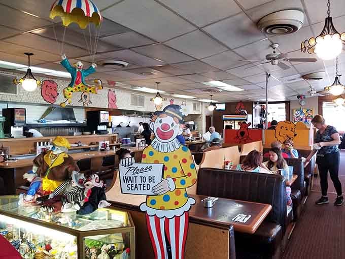 A parachuting clown and a "Please Wait To Be Seated" sign greet you, and honestly, that tracks perfectly.