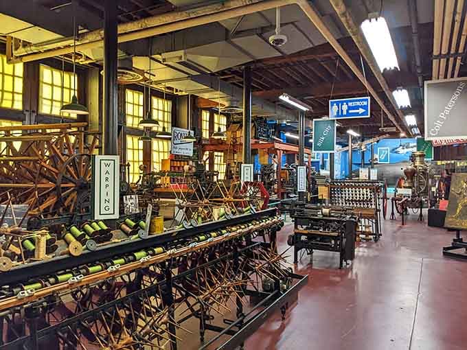 Rows of silk machinery stretch across this mill floor like a mechanical forest frozen beautifully in time.