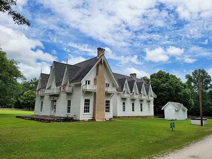 Pointed gables, decorative trim, and enough history to fill a library, all sitting on a perfect green lawn.