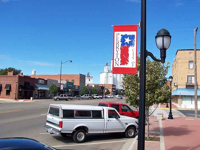 A bold red and blue City of Perryton banner catches the breeze while pickup trucks line the street below like loyal old friends.