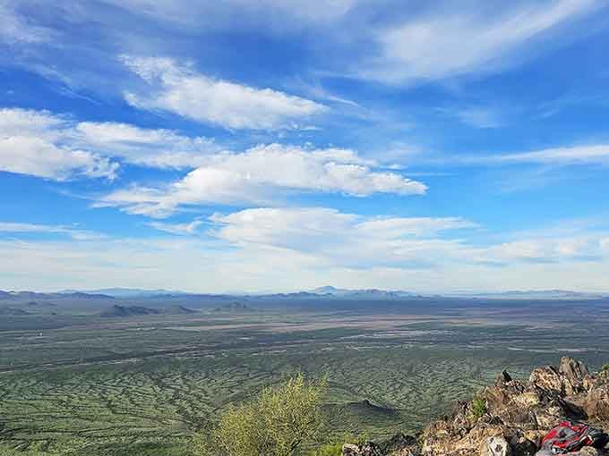 From up here, Arizona stretches out like God's own welcome mat, mountains kissing the horizon in every direction.