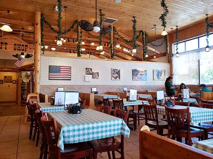 Warm wood, checkered tablecloths, and hanging greenery. This room says "stay a while" and means it.