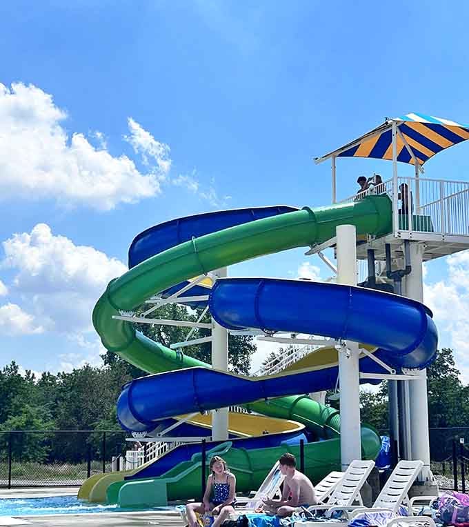 Lounge chairs, sunshine, and colorful slides in the background. Somebody clearly figured out the formula for a perfect summer afternoon.