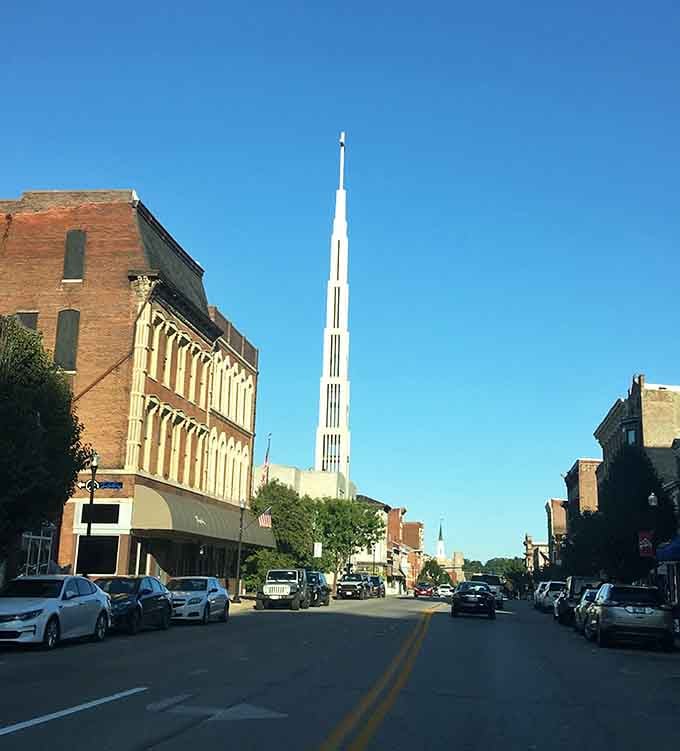 Historic brick buildings and a bold church spire share the same street, reminding you that this city has always aimed high.