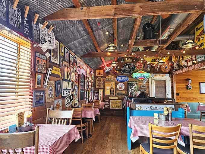 Walls covered in vintage signs and warm wooden beams, this dining room tells stories before the food even arrives.