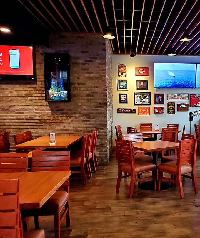 Brick walls, warm wood, and sports signs everywhere, this dining room feels like your favorite uncle decorated it.