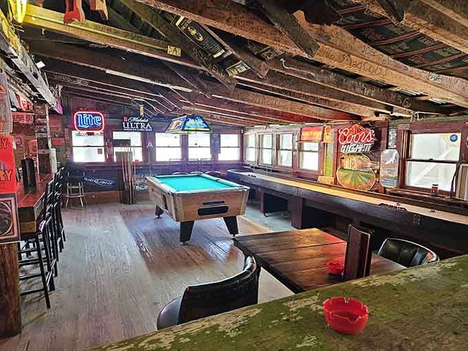 Pool tables, neon signs, and a ceiling covered in decades of signatures. History looks good up here.