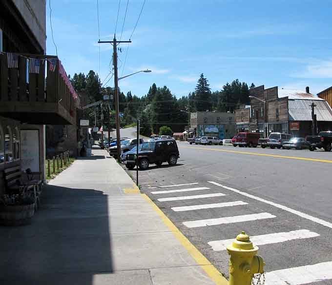 Old Glory hangs above a sidewalk where miners once walked, and somehow the whole street still feels alive.wn