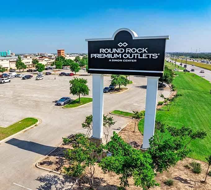 That towering sign stands proud against the Texas sky, a beacon of bargains visible from the highway like a shopping lighthouse.