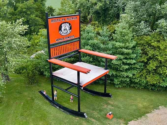From above, tiny visitors stand at the base, proving this rocking chair means serious, steel-framed business.