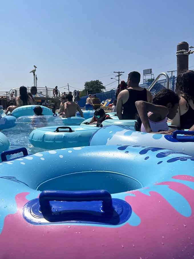 A parade of blue and pink inner tubes drifting along, carrying people who've made the very wise decision to just float.