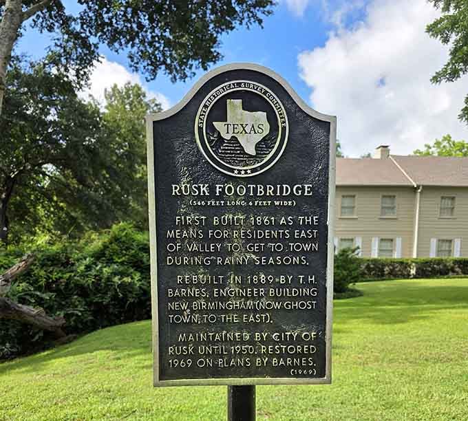 History carved in iron, telling the story of a bridge that outlasted an entire ghost town nearby.